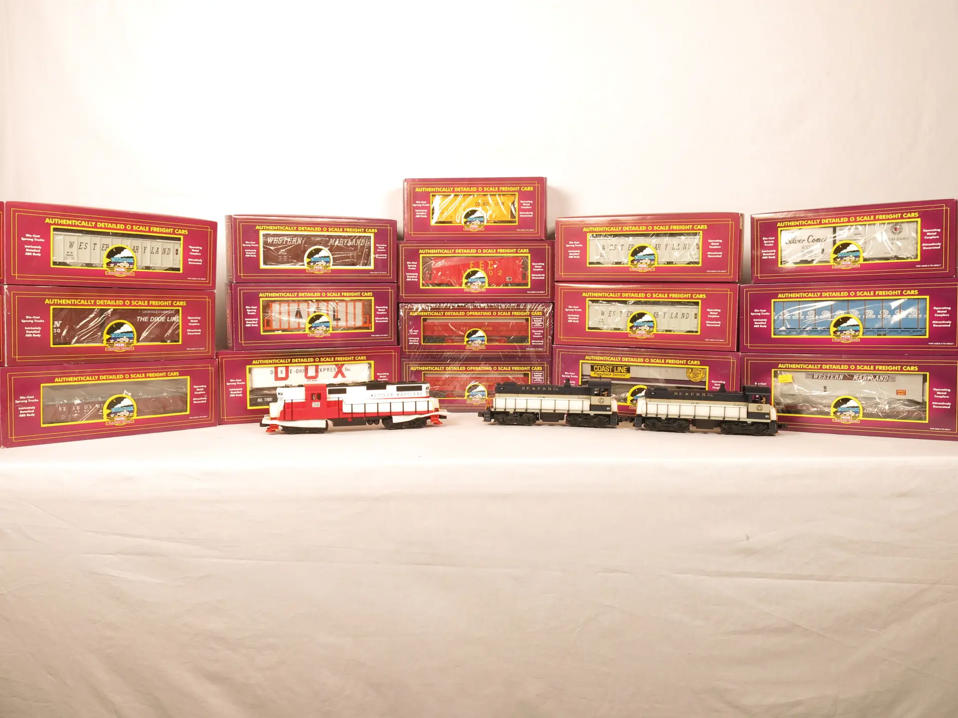 Three MTH O Gauge Diesel Engines with Sixteen Rolling Stock Cars ...