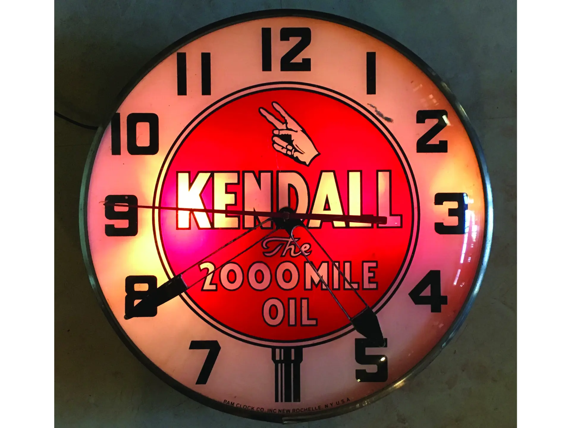 An illuminated Kendall 2000 mile oil by Pam Clock Co., 14.5" diameter ...