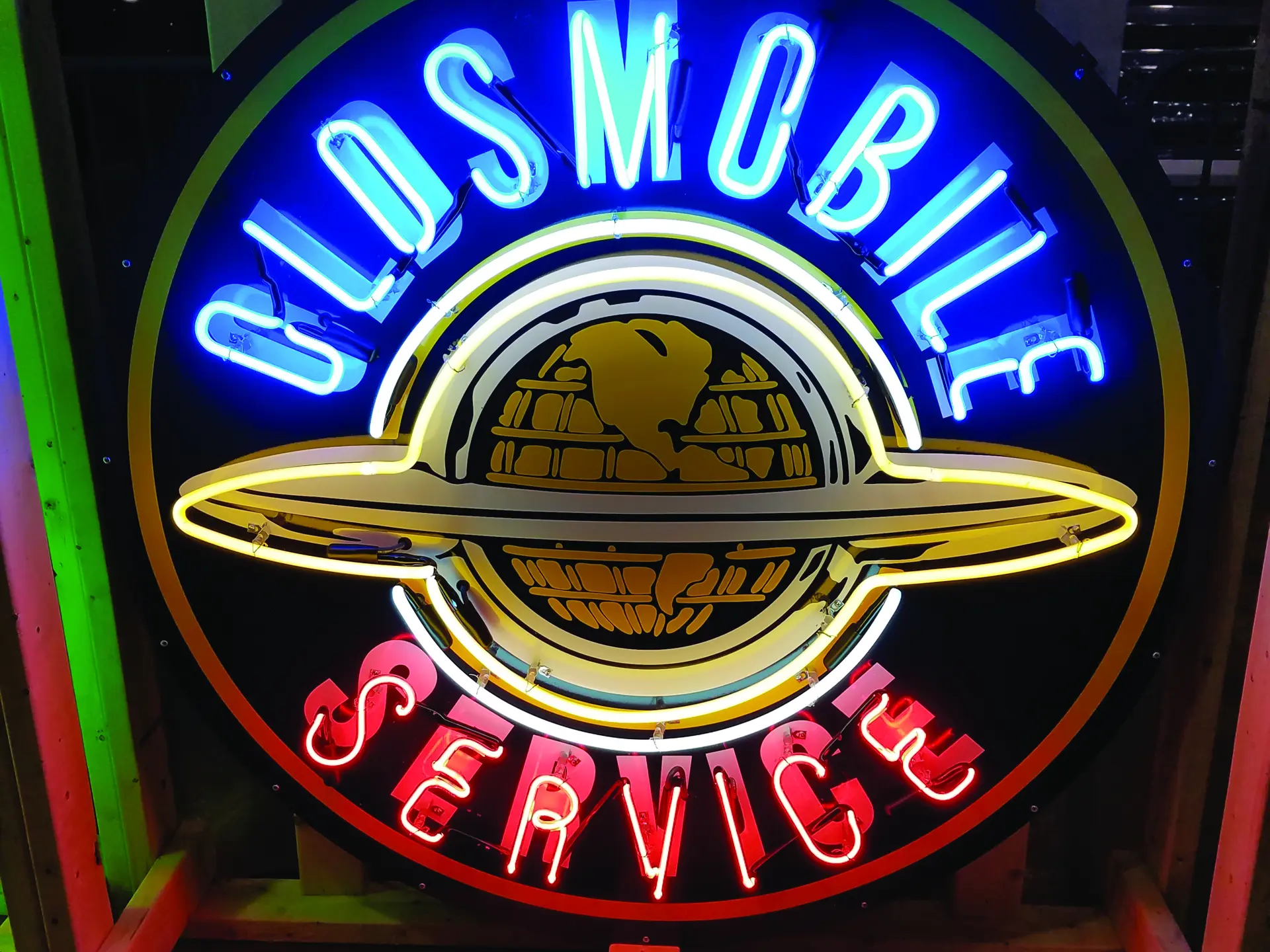 A custom, Oldsmobile, tin, neon, sign. | Auburn Spring 2017 | RM Sotheby's