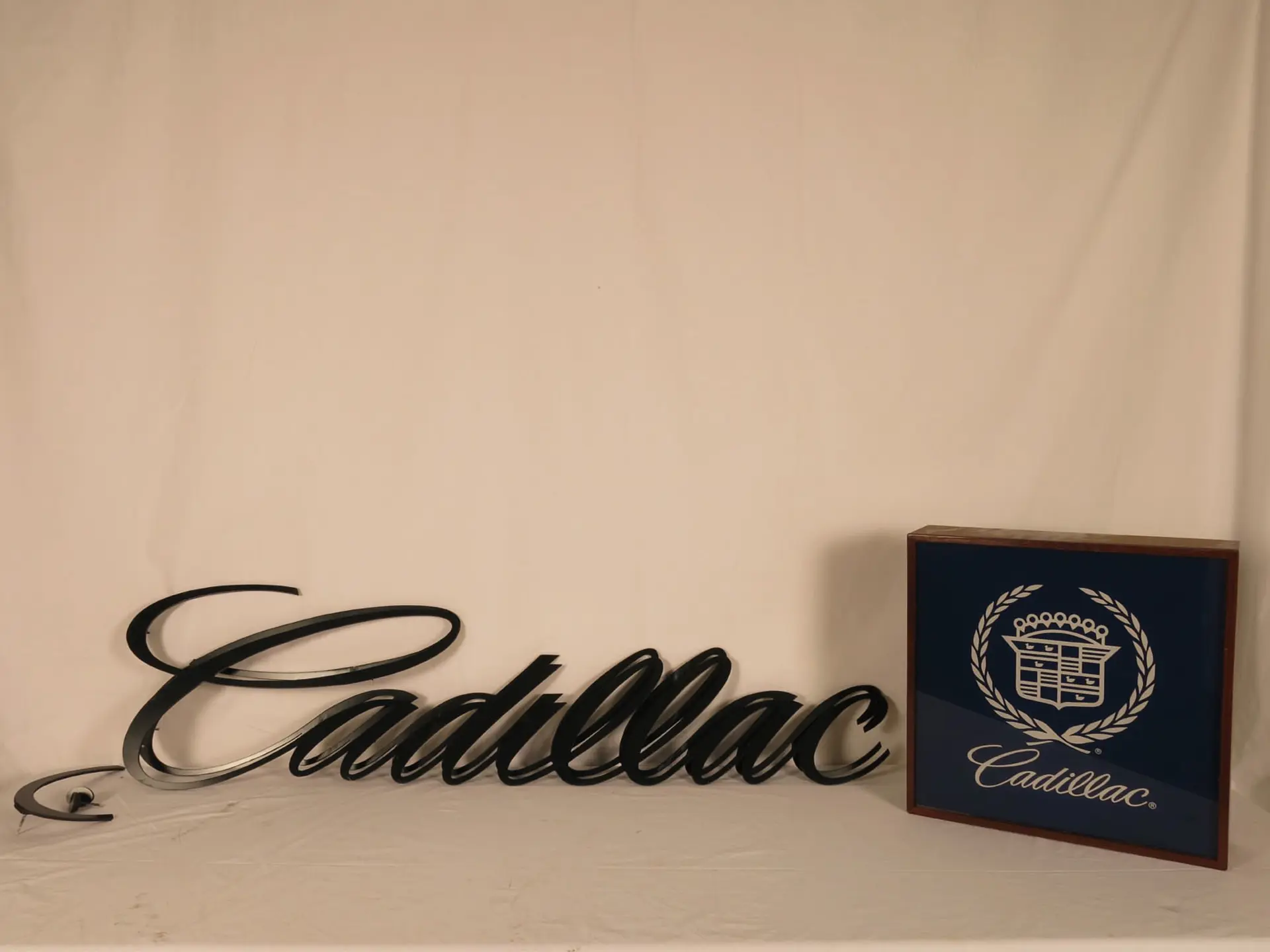 Two Cadillac dealer emblem signs and wood framed plastic lens Cadillac ...