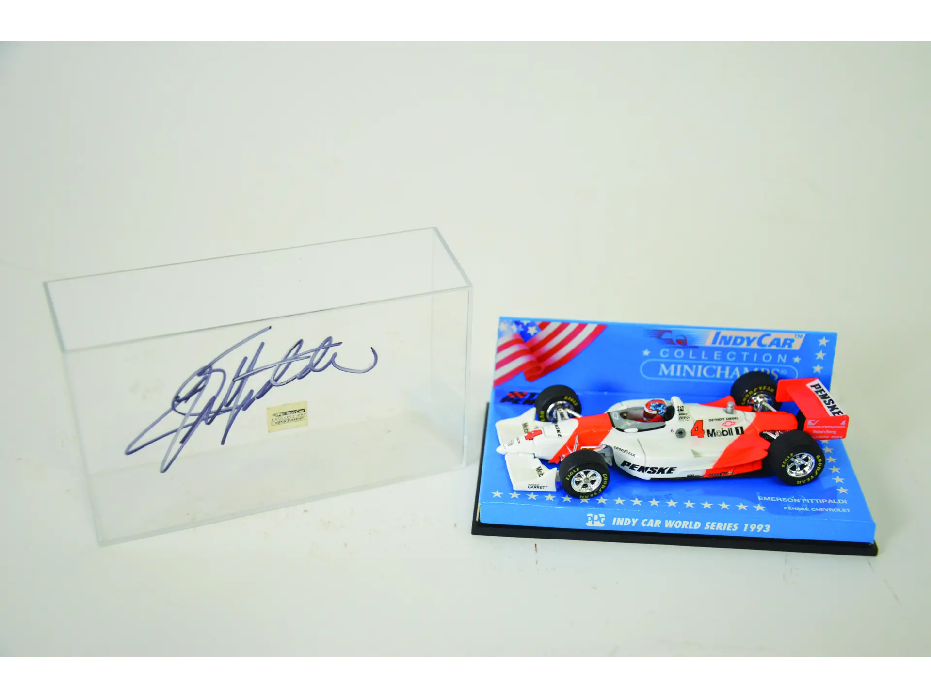 A 1/43 scale mini Champs IndyCar autographed by Emerson Fittipaldi ...