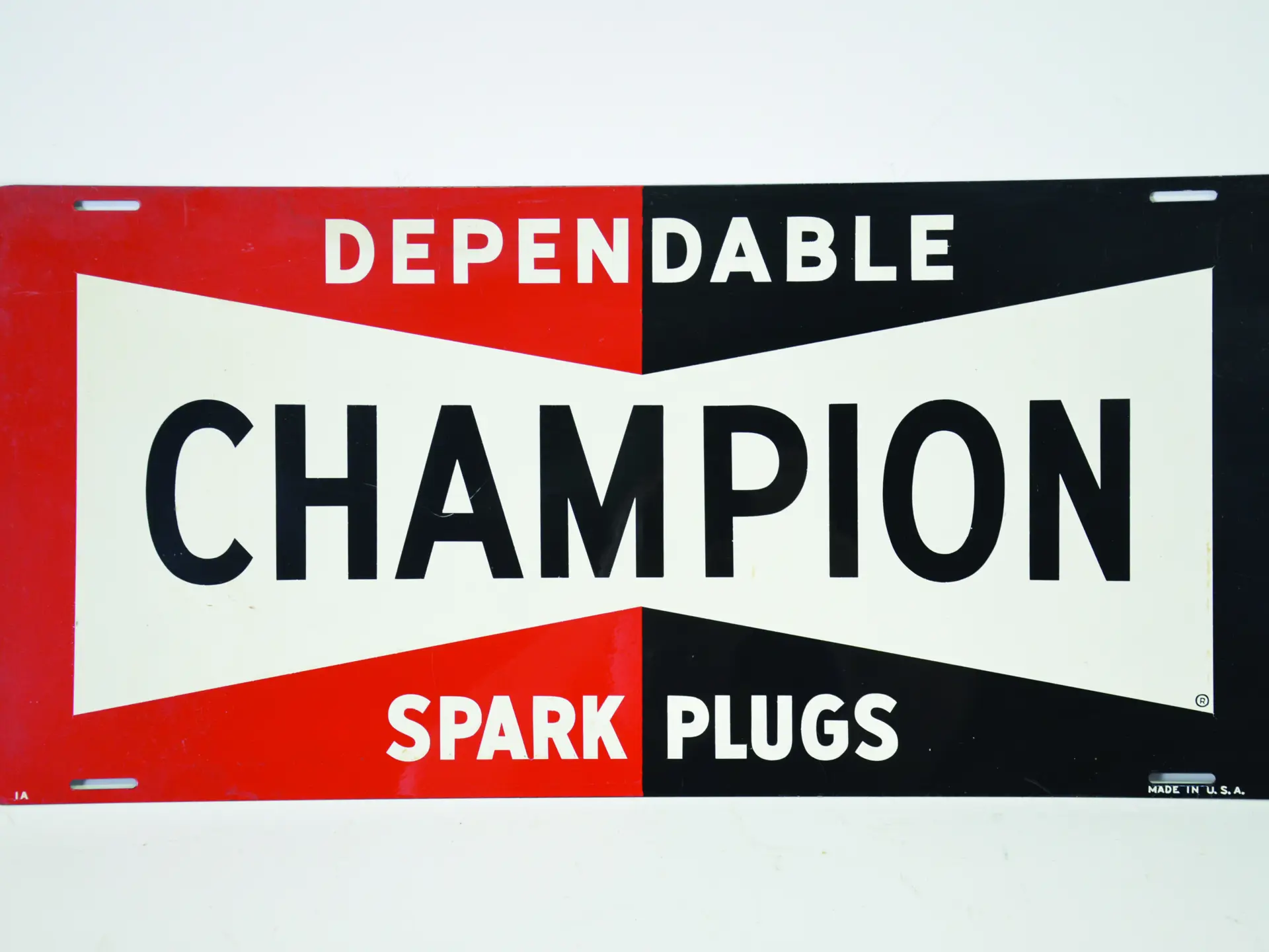A single-sided, tin painted ‘Dependable Champion spark plugs ...