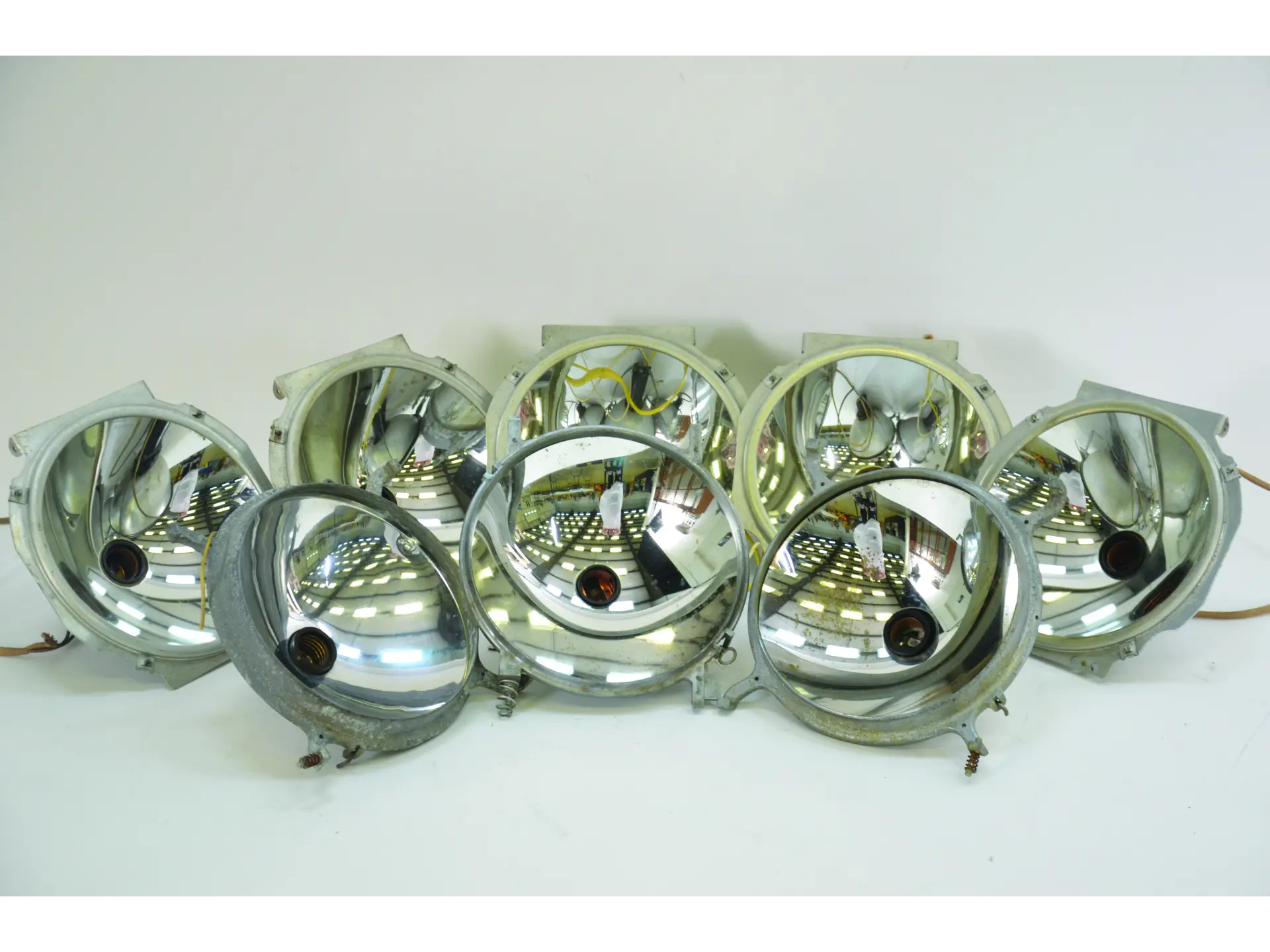 A grouping of headlamp reflectors with wiring harness brand unknown ...