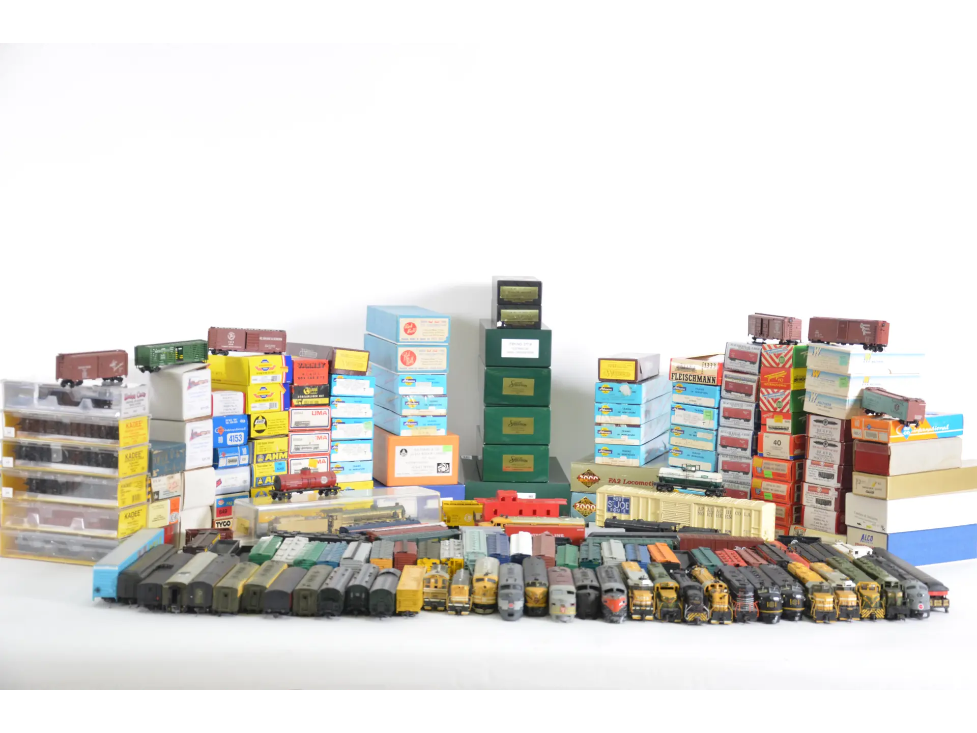 A large grouping of new old stock HO scale model train cars and engines ...