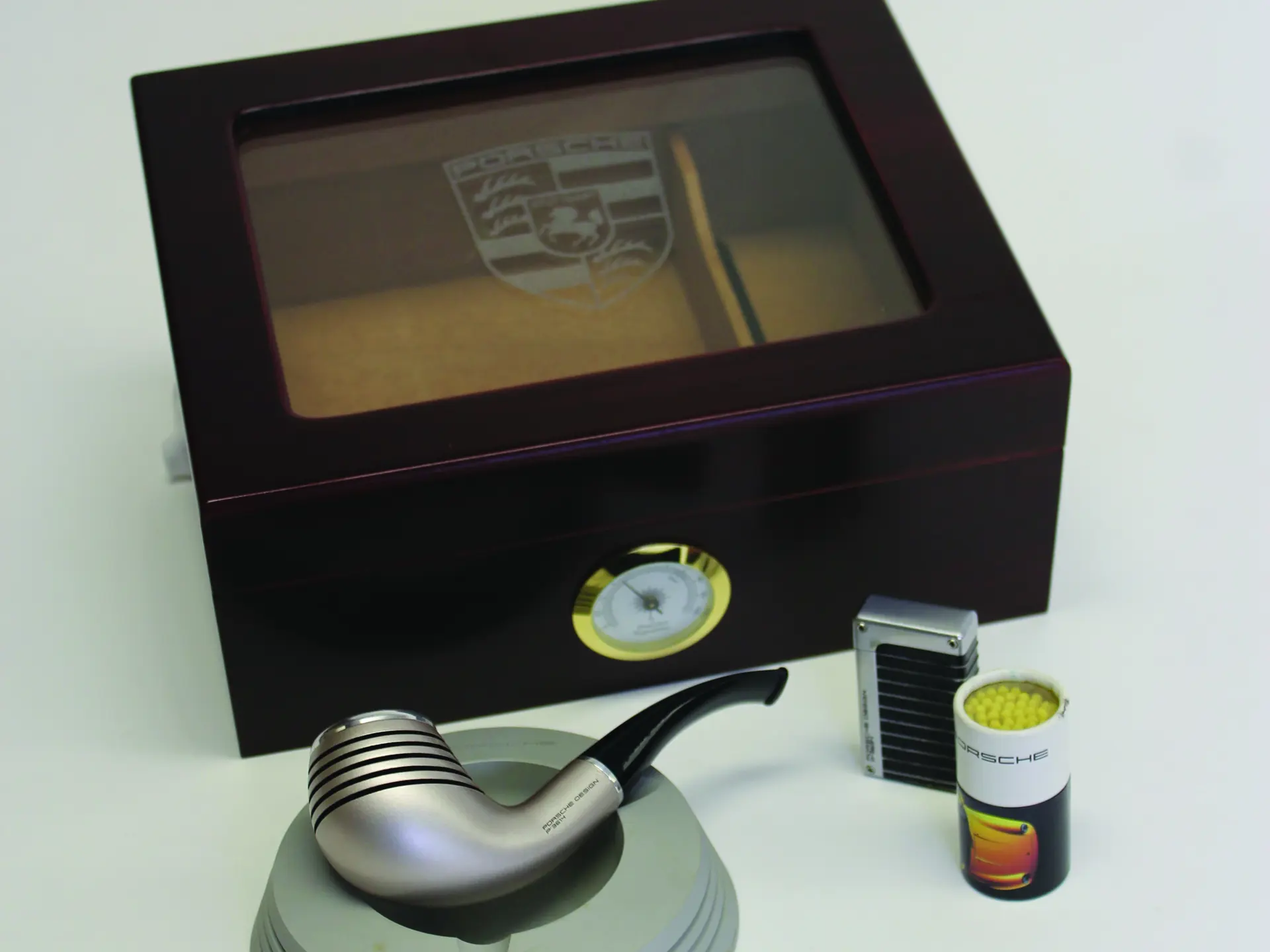Porsche branded humidor together with a Porsche Design pipe, ashtray ...